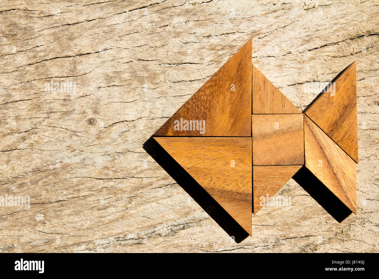 Wooden tangram puzzle in fish shape with copy space background Stock ...