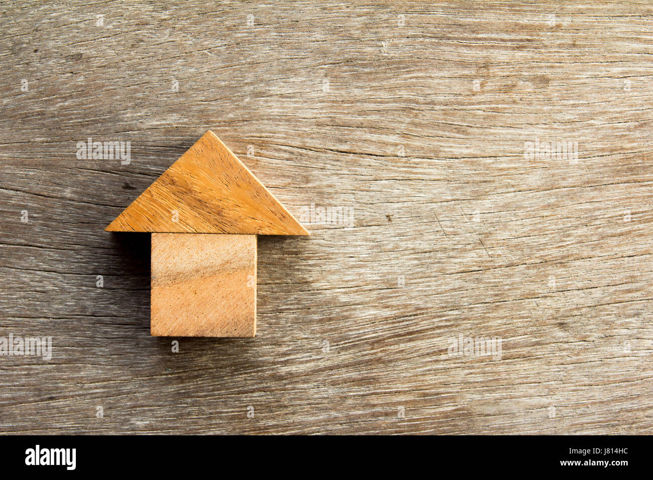 Wooden tangram puzzle in home shape for dream home or happy life ...