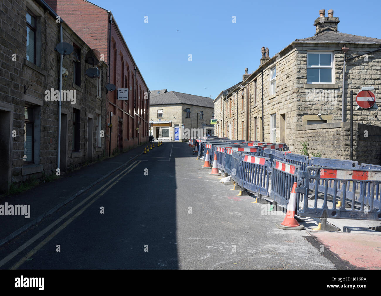 Narrow ramsbottom street half in shadow and the other half with ...