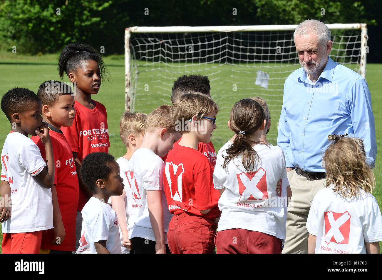 Labour Party leader Jeremy Corbyn speaks to children during a visit to ...