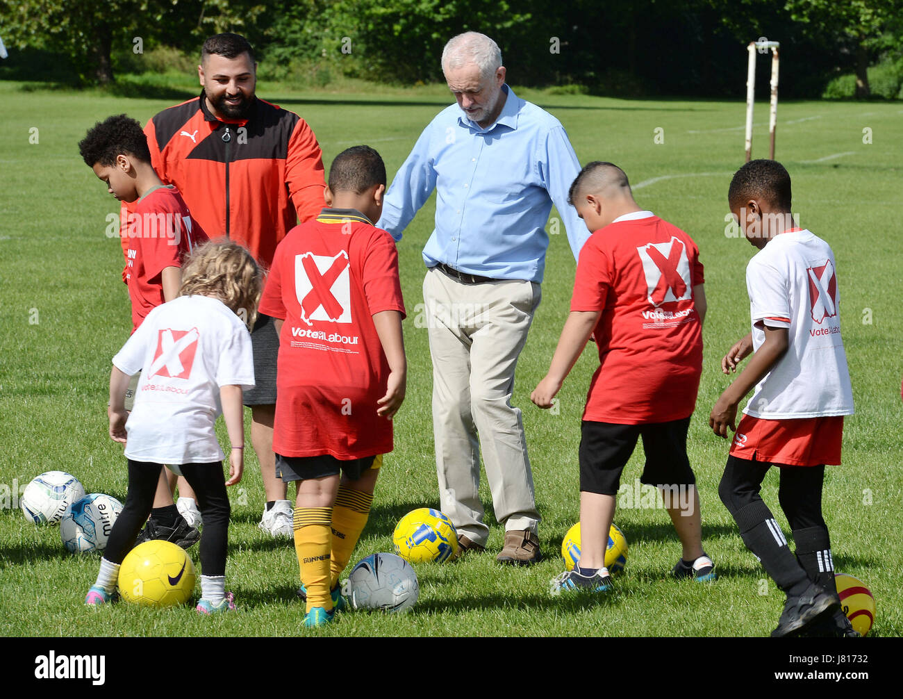Labour Party leader Jeremy Corbyn plays football with children during a ...