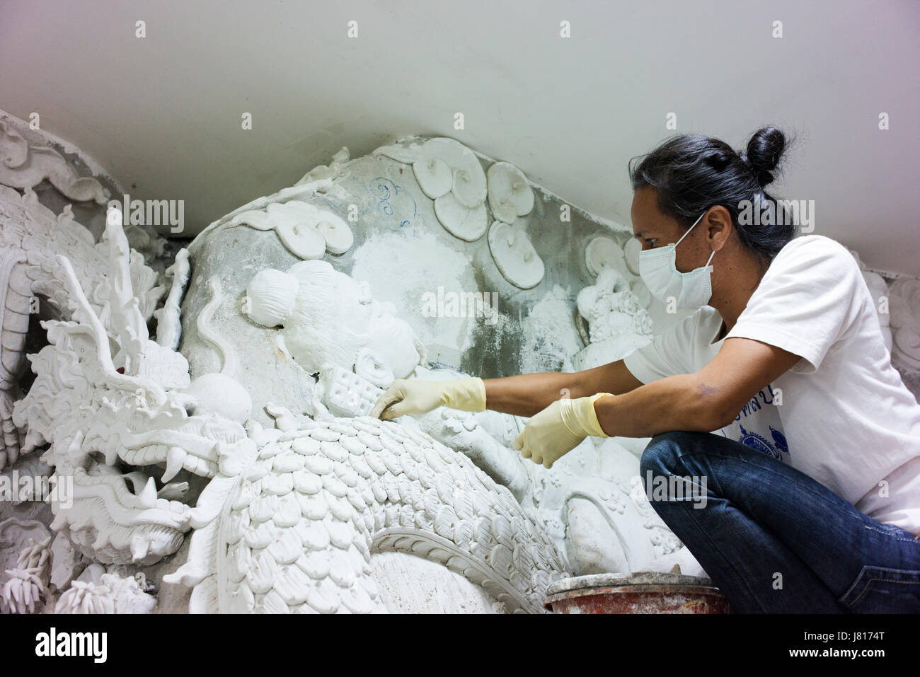 Craftsman works on mythical figures inside the giant Buddha at Wat Huai ...