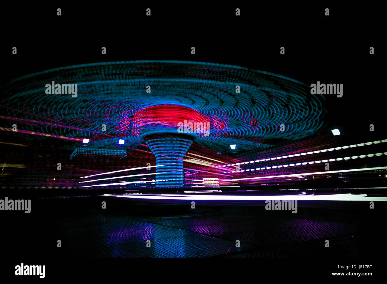 Creative edit of a light trace from 'The Twister' funfair ride at the ...