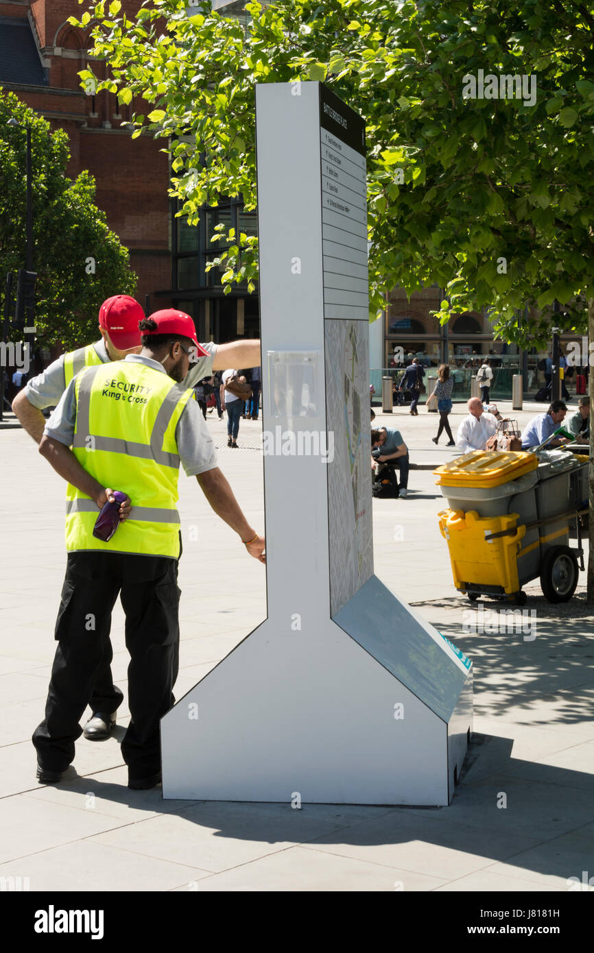 Two security guards outside Kings Cross Station Stock Photo - Alamy