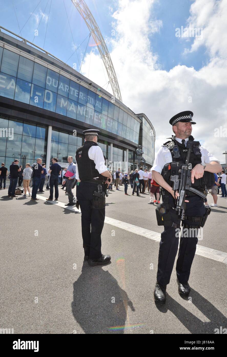 Armed police officers patrol outside Wembley Stadium ahead of the FA ...