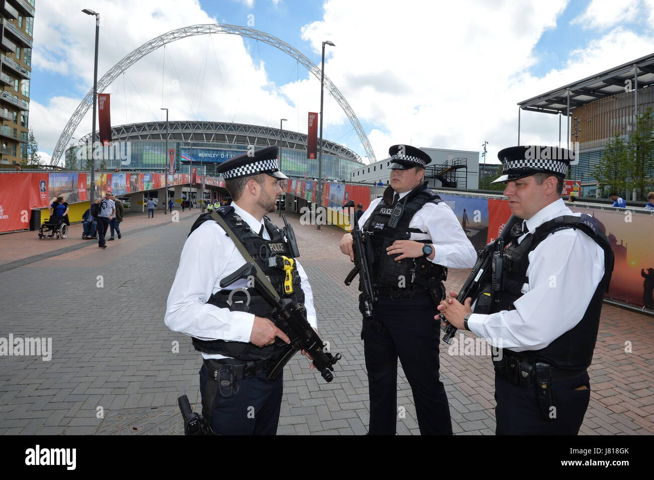 Armed police officers patrol outside Wembley Stadium ahead of the FA ...