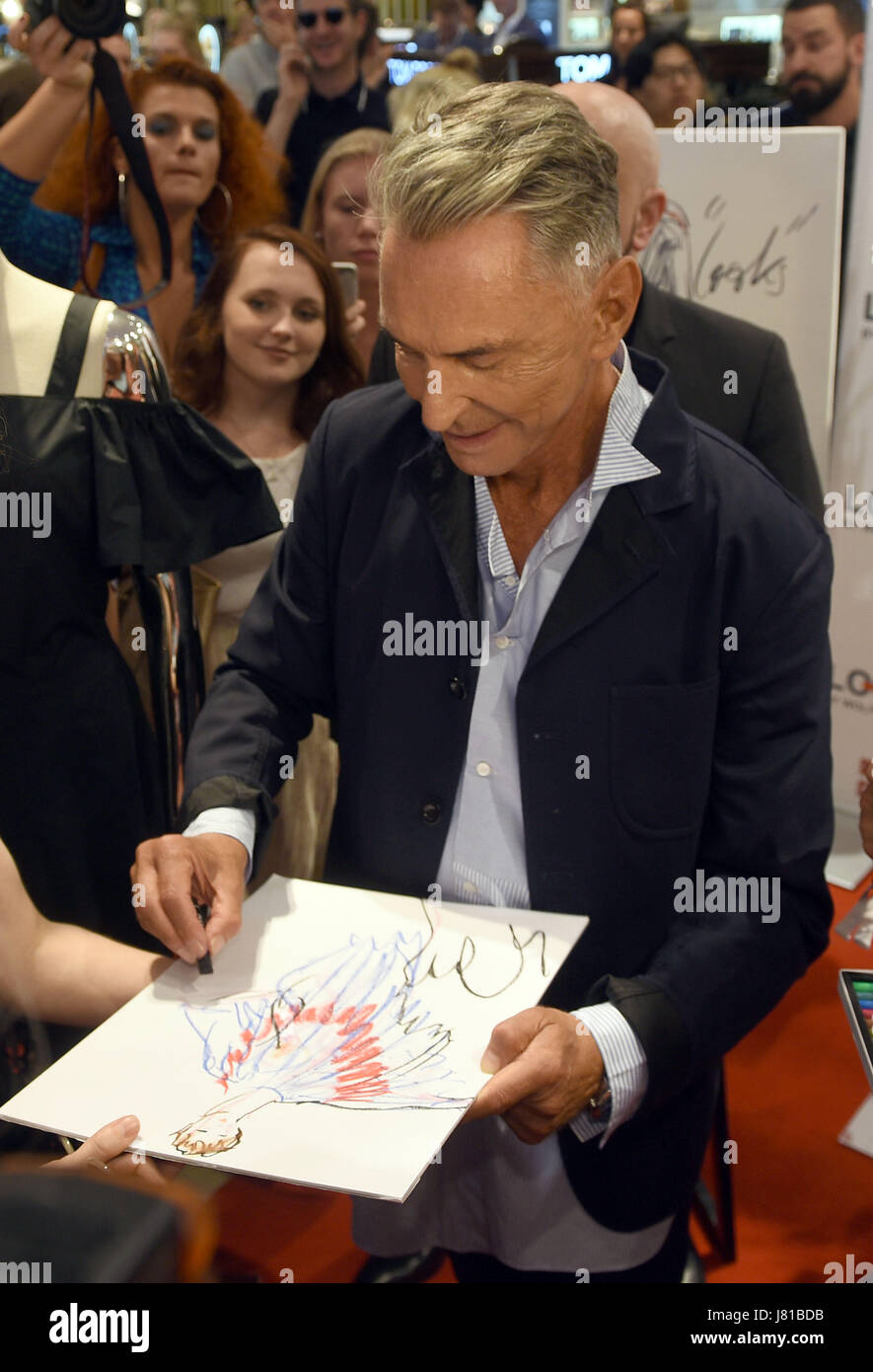 Fashion designer Wolfgang Joop draws a clothing design at the ...