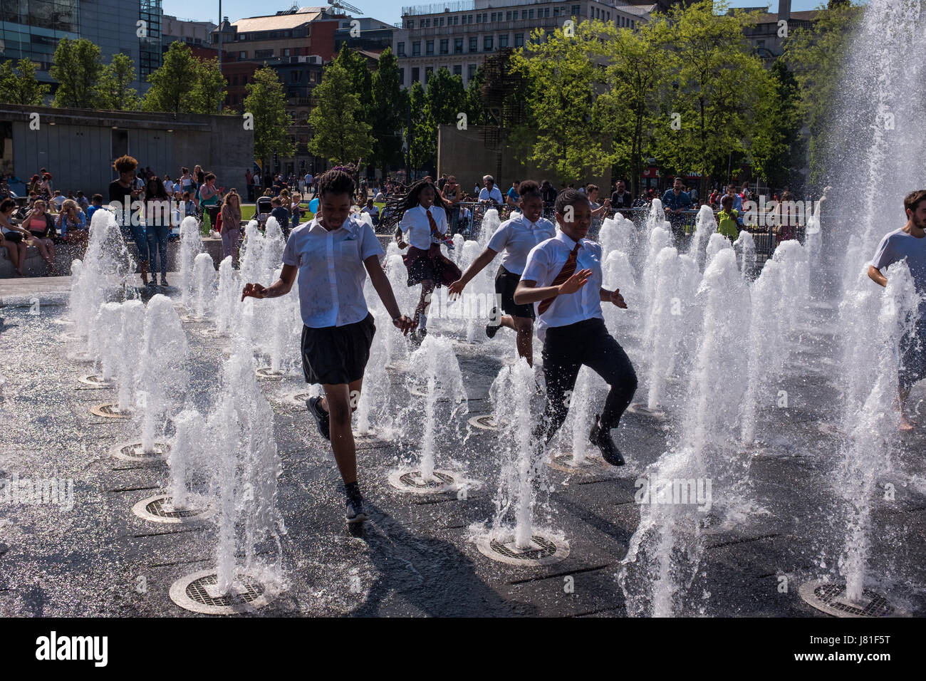 School child playing in the water spray hi-res stock photography and ...