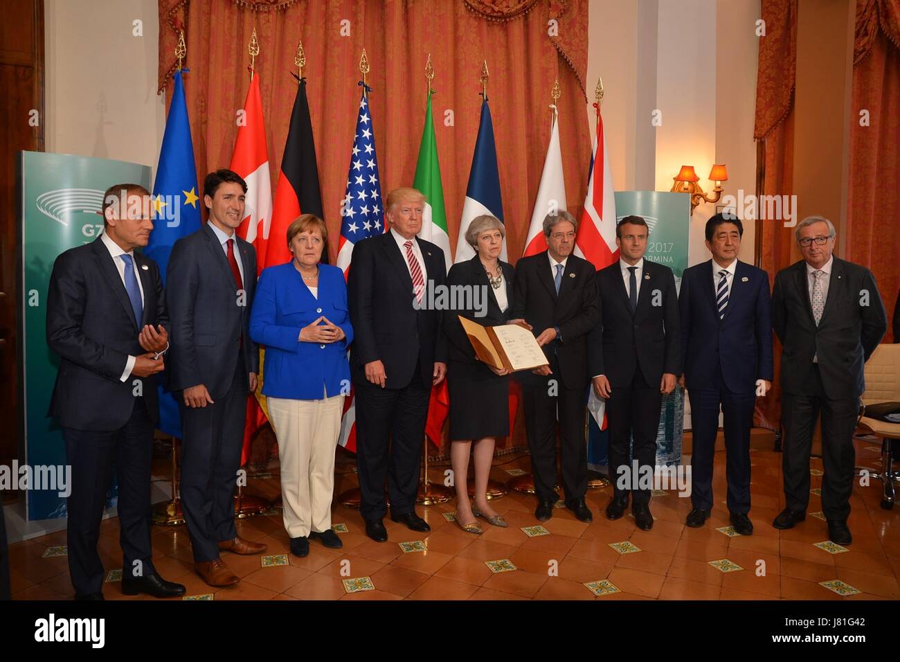 Taormina, Italy. 26th May, 2017. World leaders stand together at the G7 ...