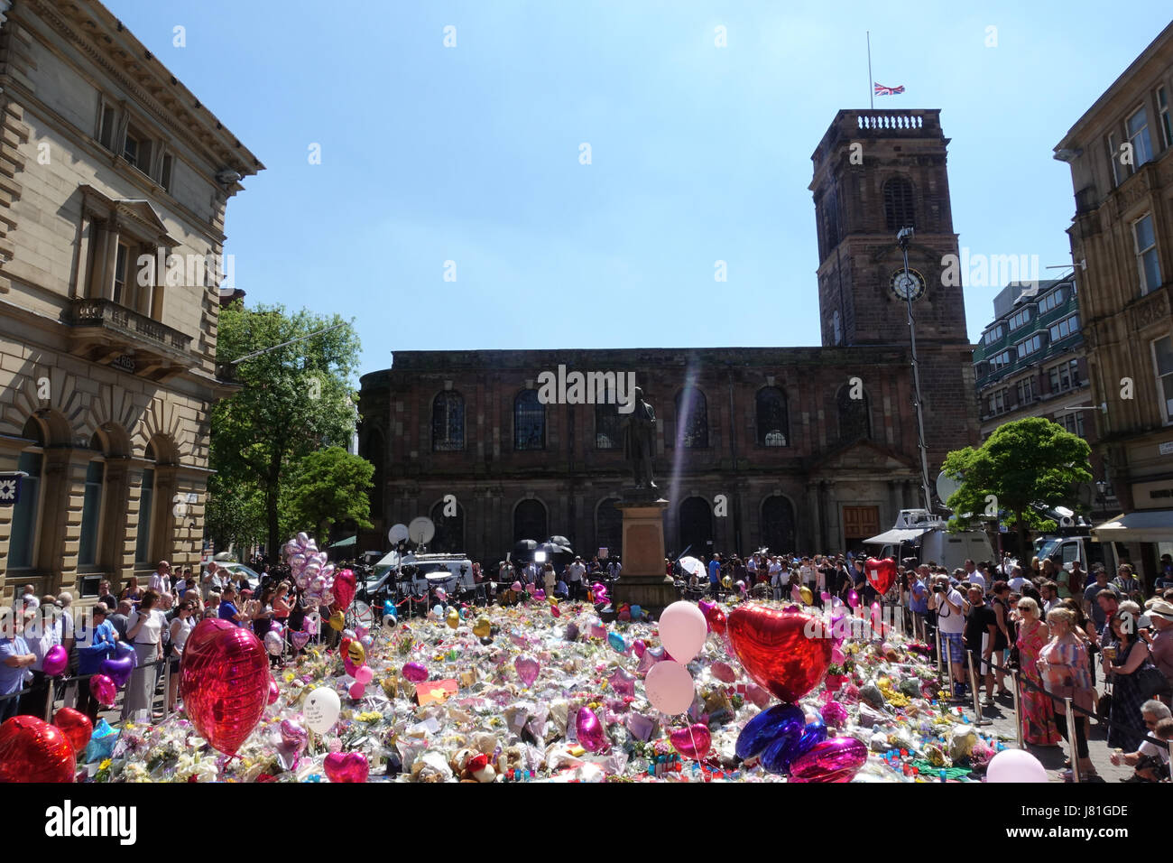 A sea of balloons and flowers carpet St Anns Square as mourners bring ...