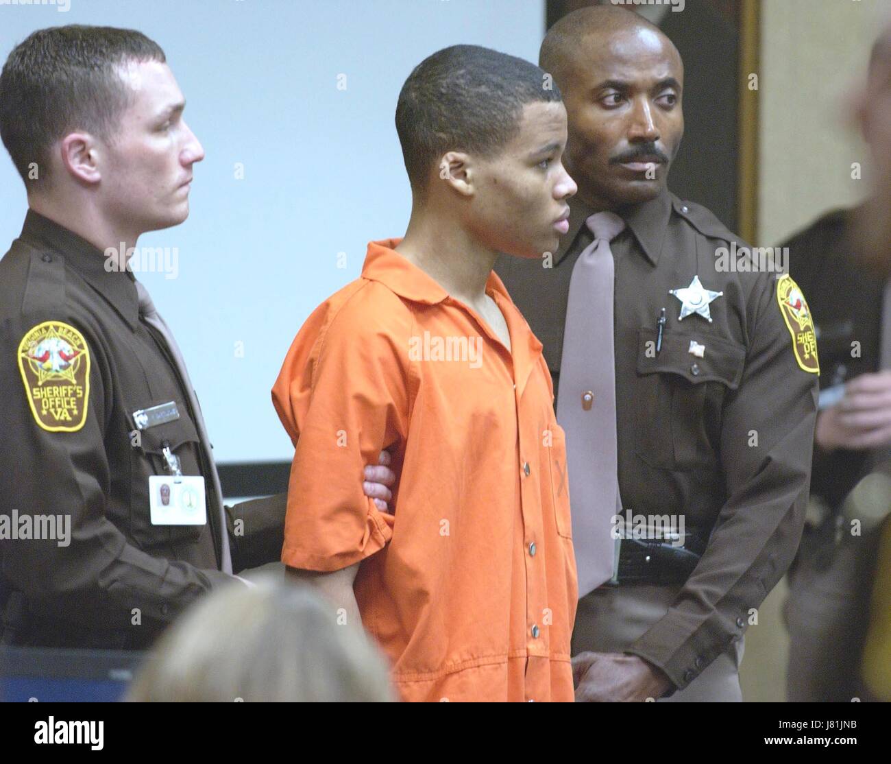 Sniper suspect Lee Boyd Malvo, center, is surrounded by deputies as he ...