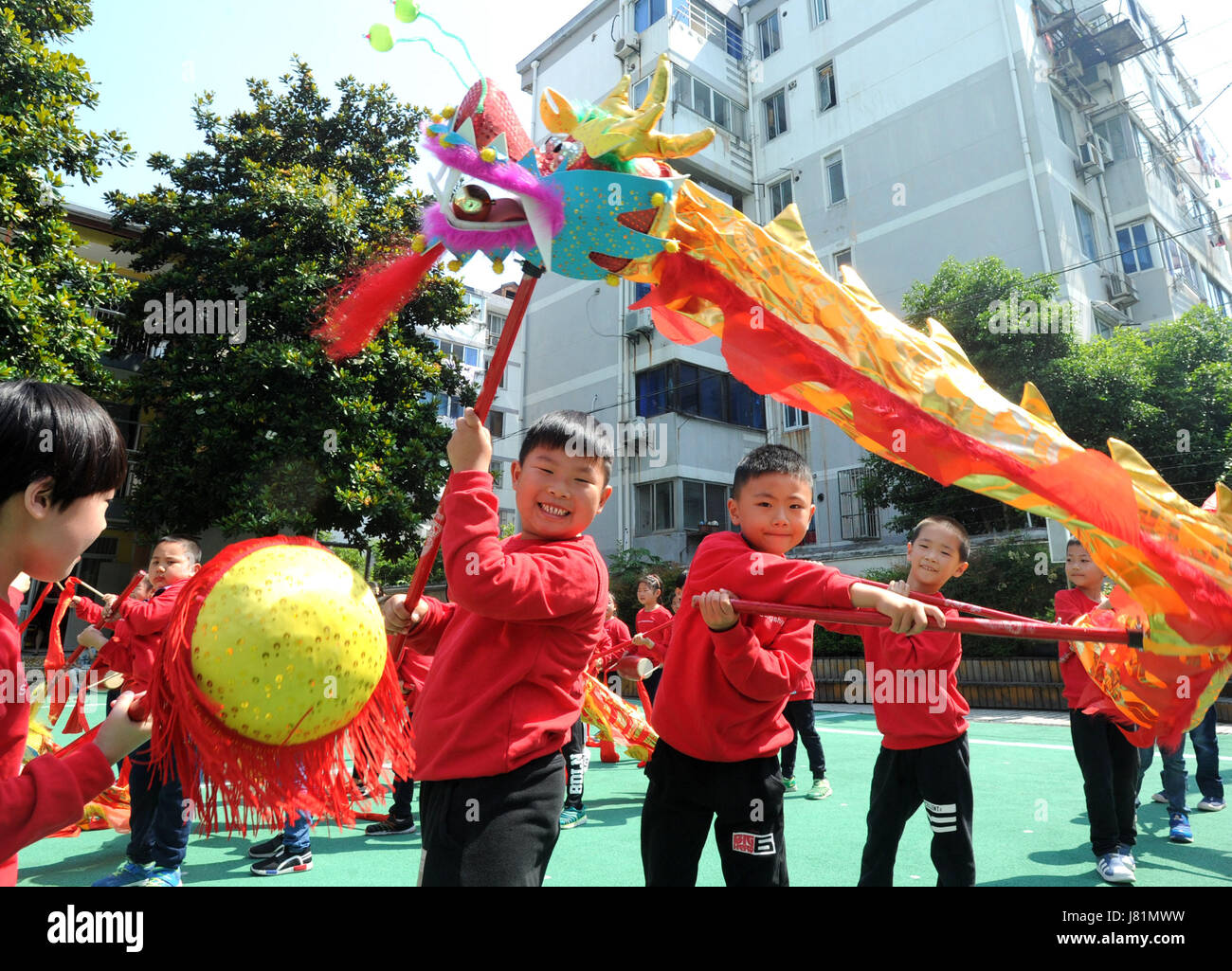 Suzhou. 27th May, 2017. Children perform dragon dance at a kindergarten ...