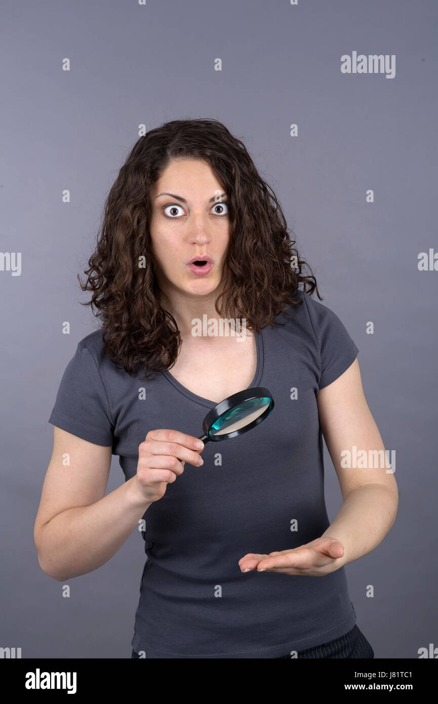 woman with magnifying glass in front of face Stock Photo - Alamy