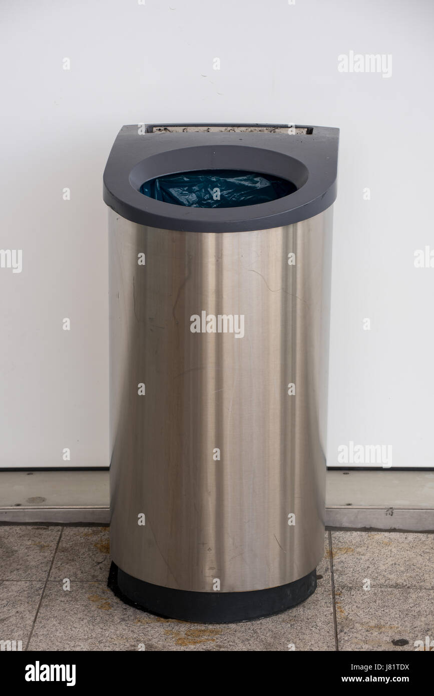 Dustbin with ashtray in front of a white wall Stock Photo - Alamy