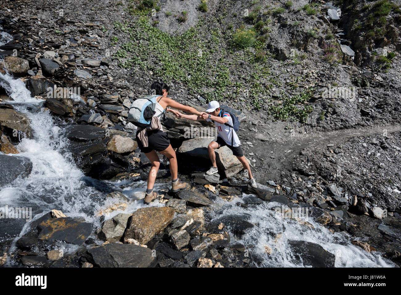Young woman crossing a river hi-res stock photography and images - Alamy