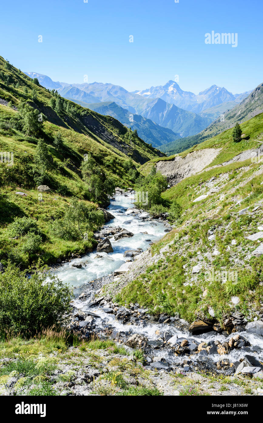 A river and a green valley in the Alps mountains during summer, Isere ...