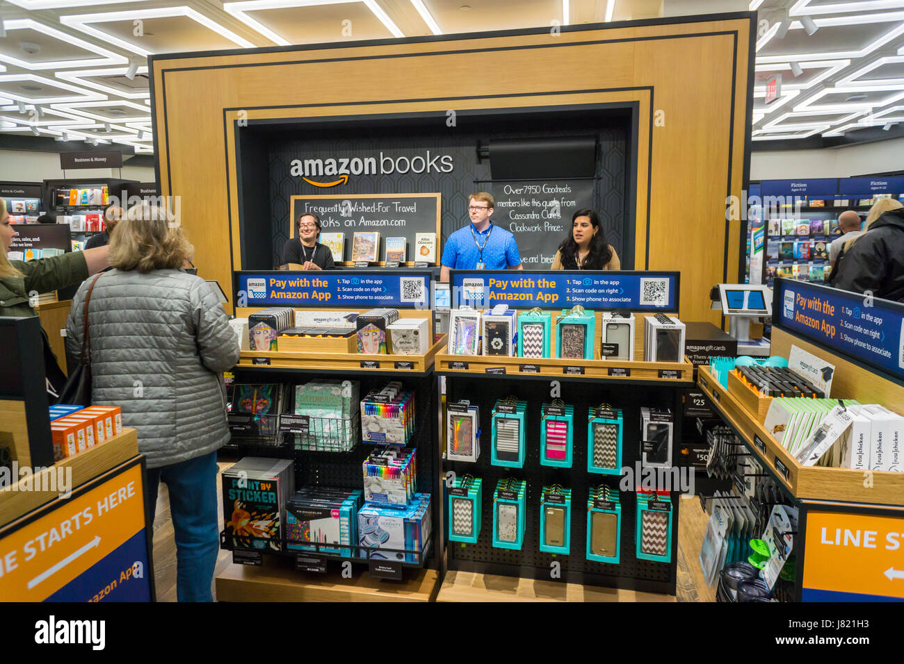 Customers shop and browse in the new Amazon Books in the Time Warner ...