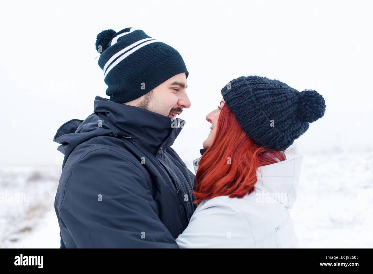 Picture of a cute couple on a winter background Stock Photo - Alamy