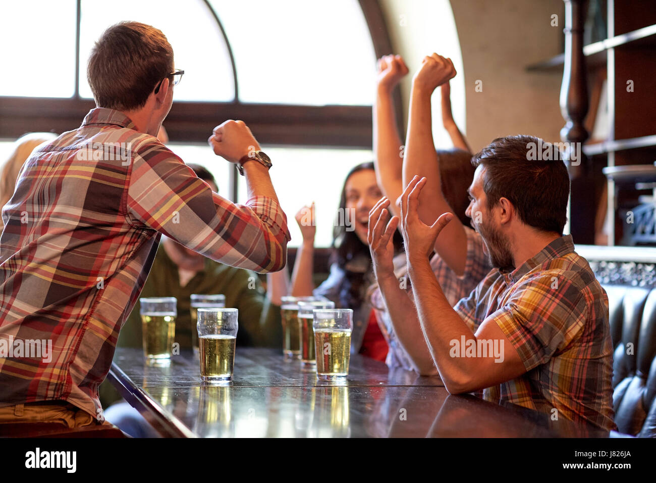football fans or friends with beer at sport bar Stock Photo - Alamy