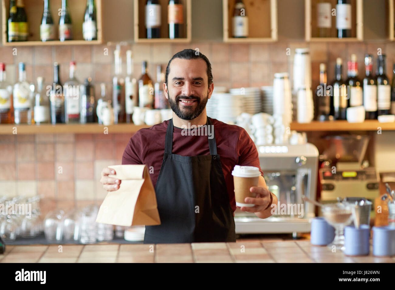 man or waiter with coffee and paper bag at bar Stock Photo - Alamy