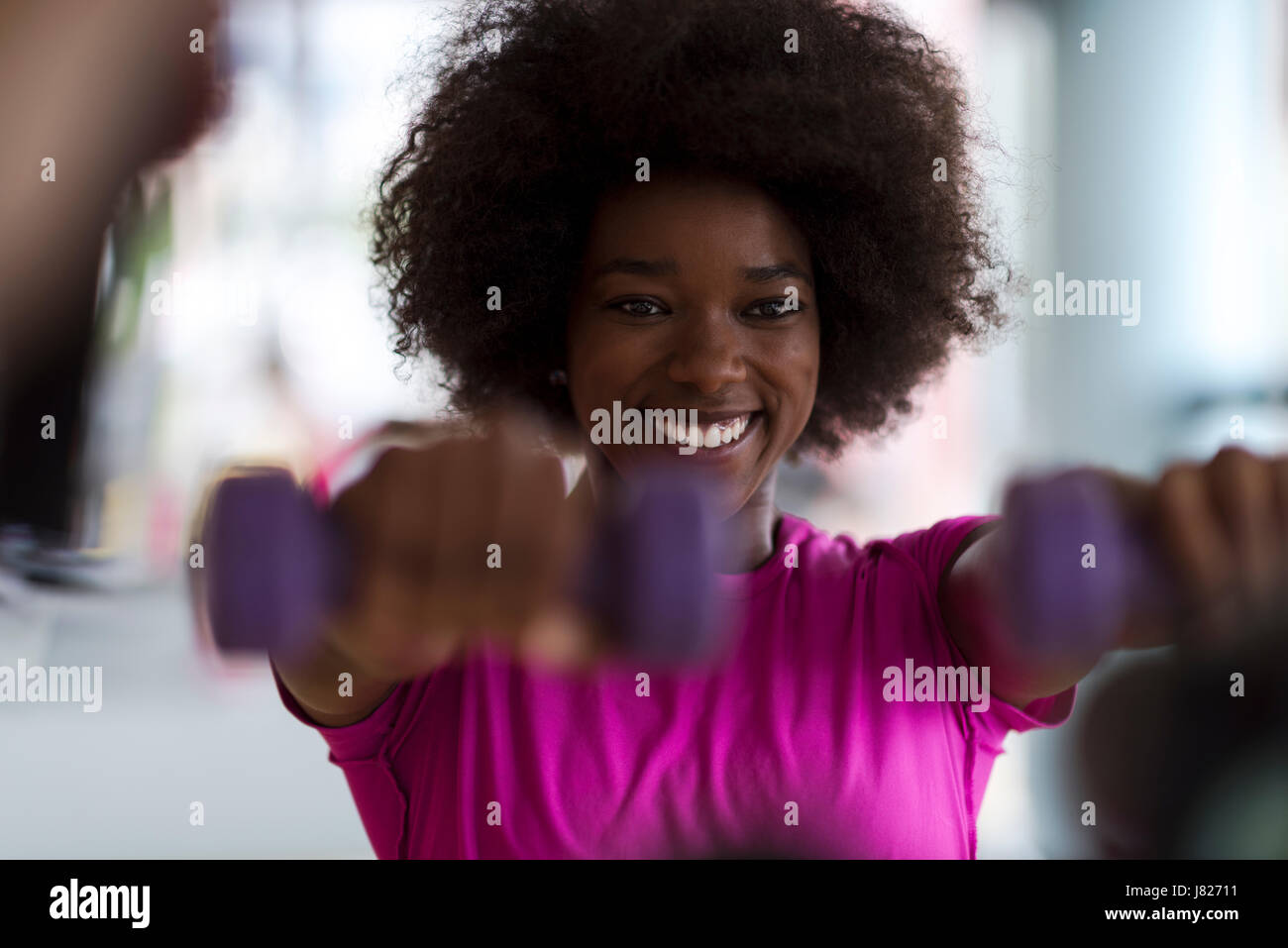 happy healthy african american woman working out in a crossfit gym on ...
