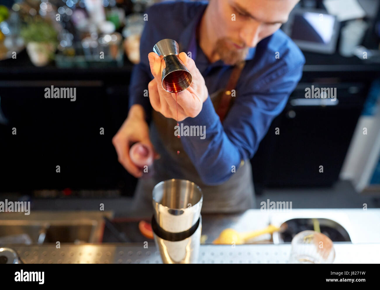 bartender with shaker preparing cocktail at bar Stock Photo - Alamy