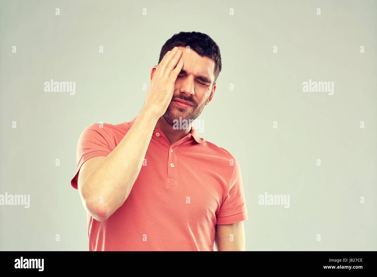 unhappy man suffering from head ache Stock Photo - Alamy