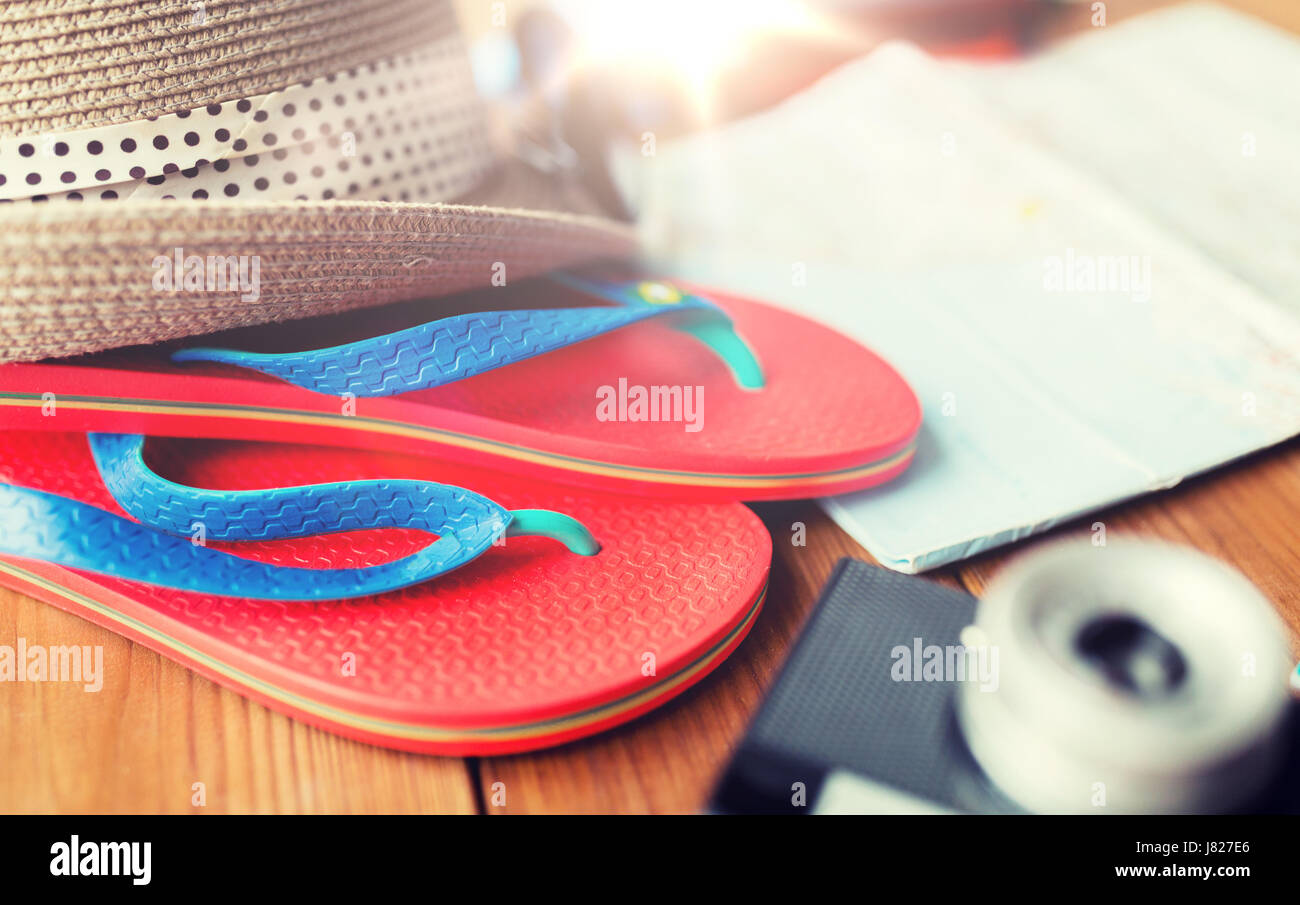 close up of travel map, flip-flops, hat and camera Stock Photo - Alamy