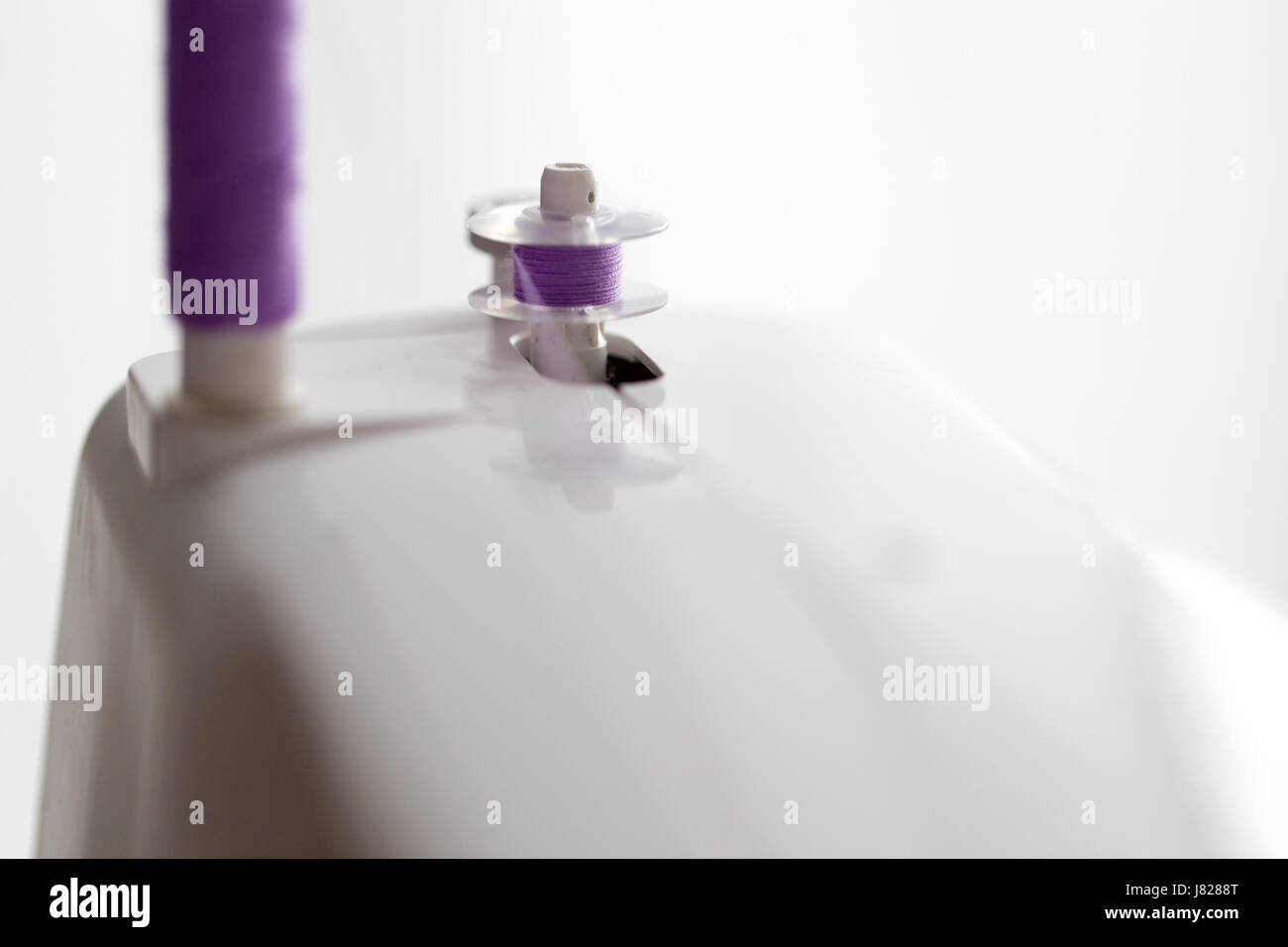 thread spools on sewing machine Stock Photo - Alamy