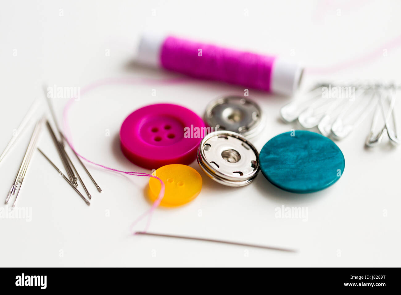 sewing buttons, needles, pins and thread spool Stock Photo - Alamy