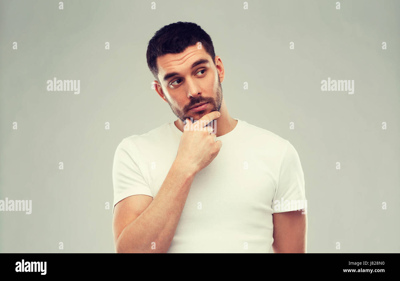 man thinking over gray background Stock Photo - Alamy