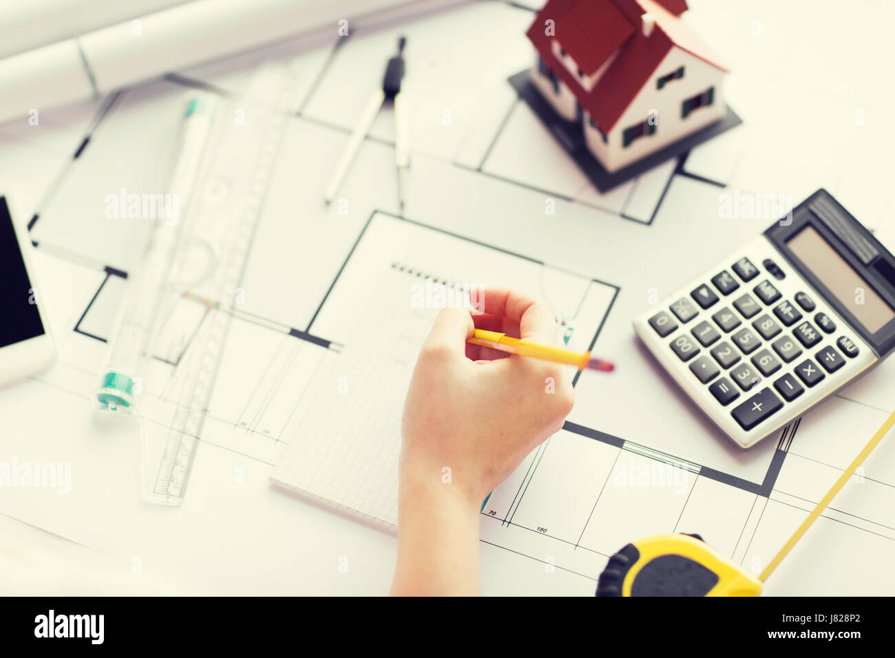 close up of hand on blueprint writing to notebook Stock Photo - Alamy