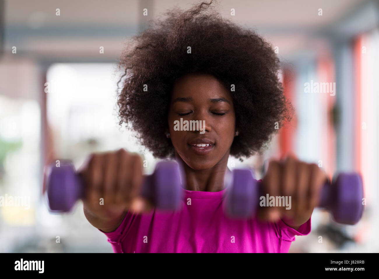 happy healthy african american woman working out in a crossfit gym on ...