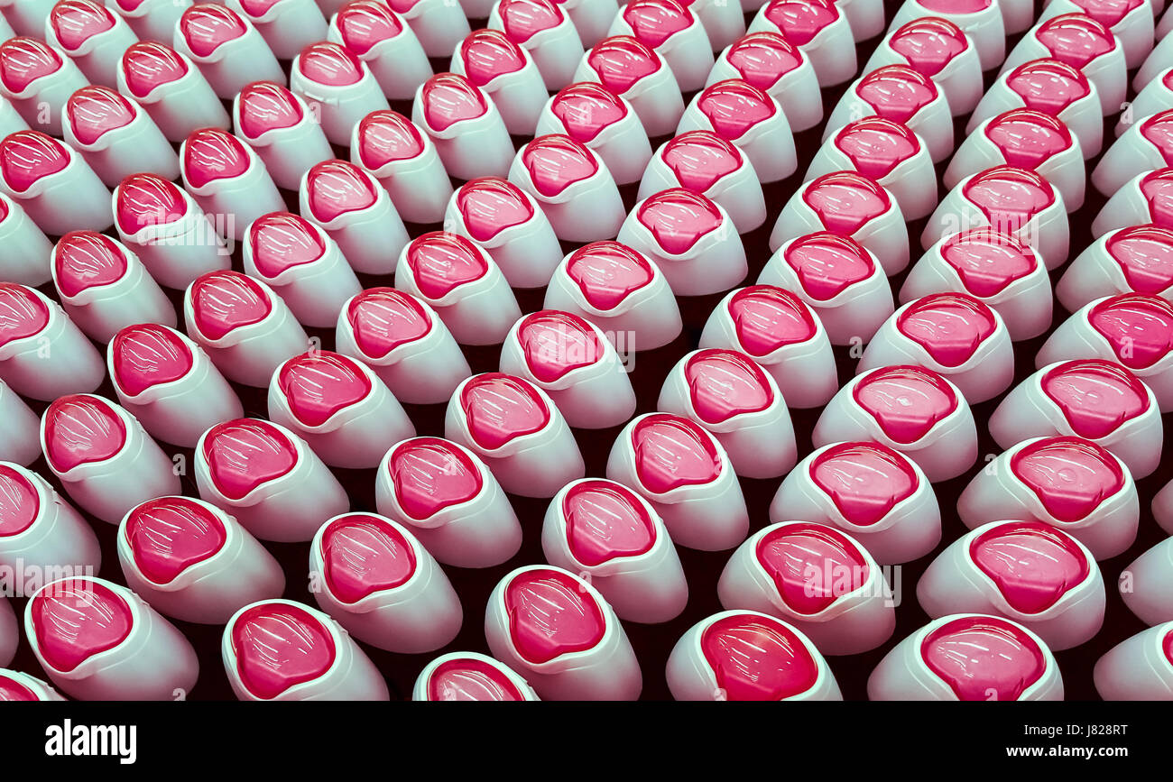 Deodorant, bottles with pink lids in a row. Background Stock Photo - Alamy