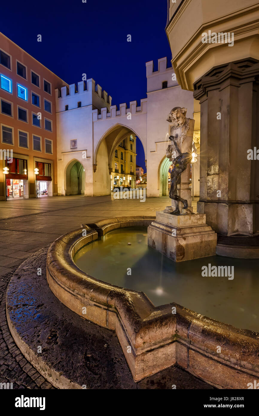 Brunnenbuberl Fountain and Karlstor Gate in the Evening, Munich ...