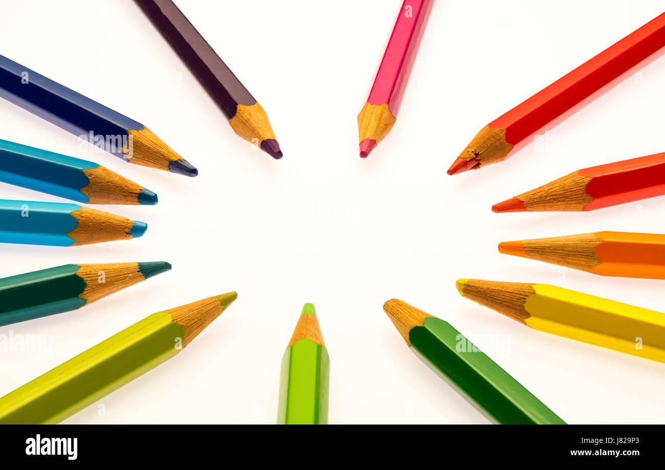 color pencils of different colors making a color wheel on white ...