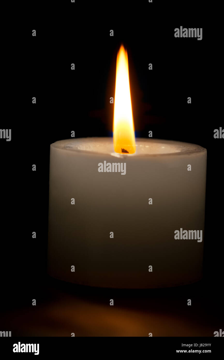 white candle with flame on black Stock Photo - Alamy