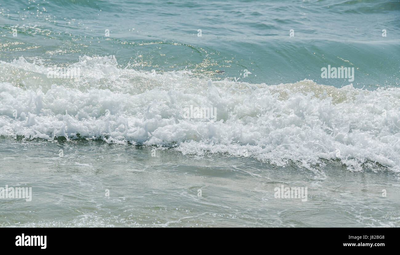 Blue, green water waves, Black Sea sandy shore, seaside with lather ...