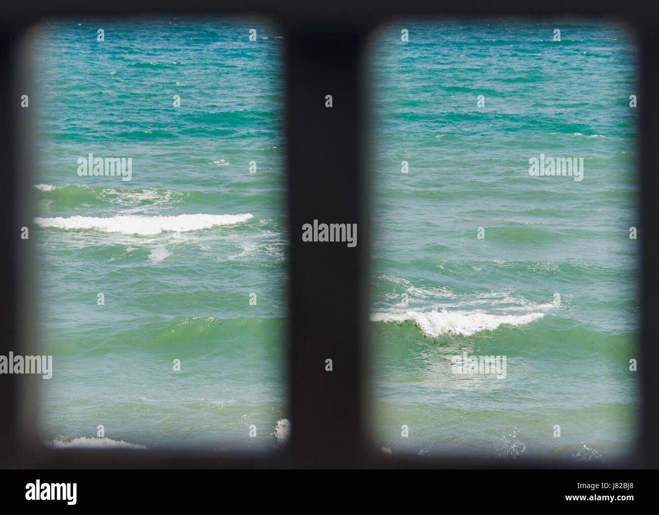 Frame window with view to blue, green sea water waves, seaside with ...