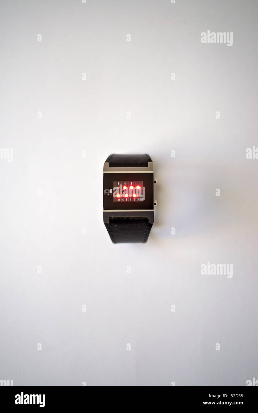 A modern binary watch with a leather strap on a clear background with ...