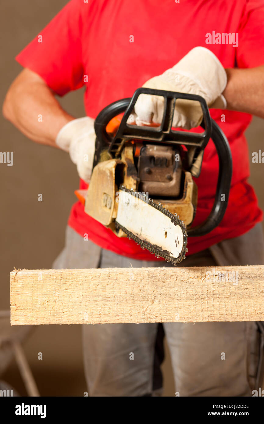 construction worker or handyman with chainsaw Stock Photo - Alamy