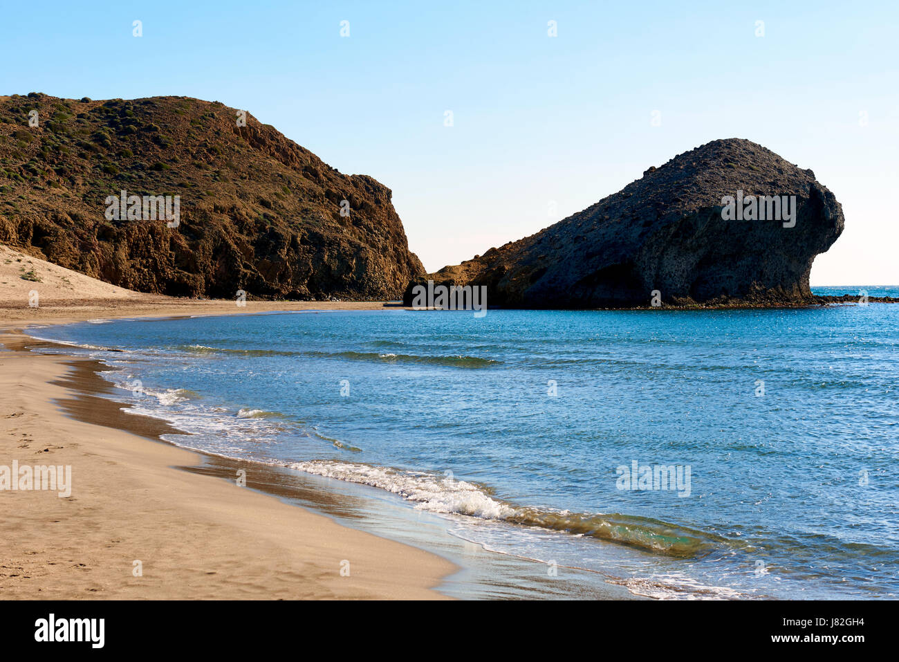 Volcanic rock-formations and crystal clear water at Playa de Monsul ...