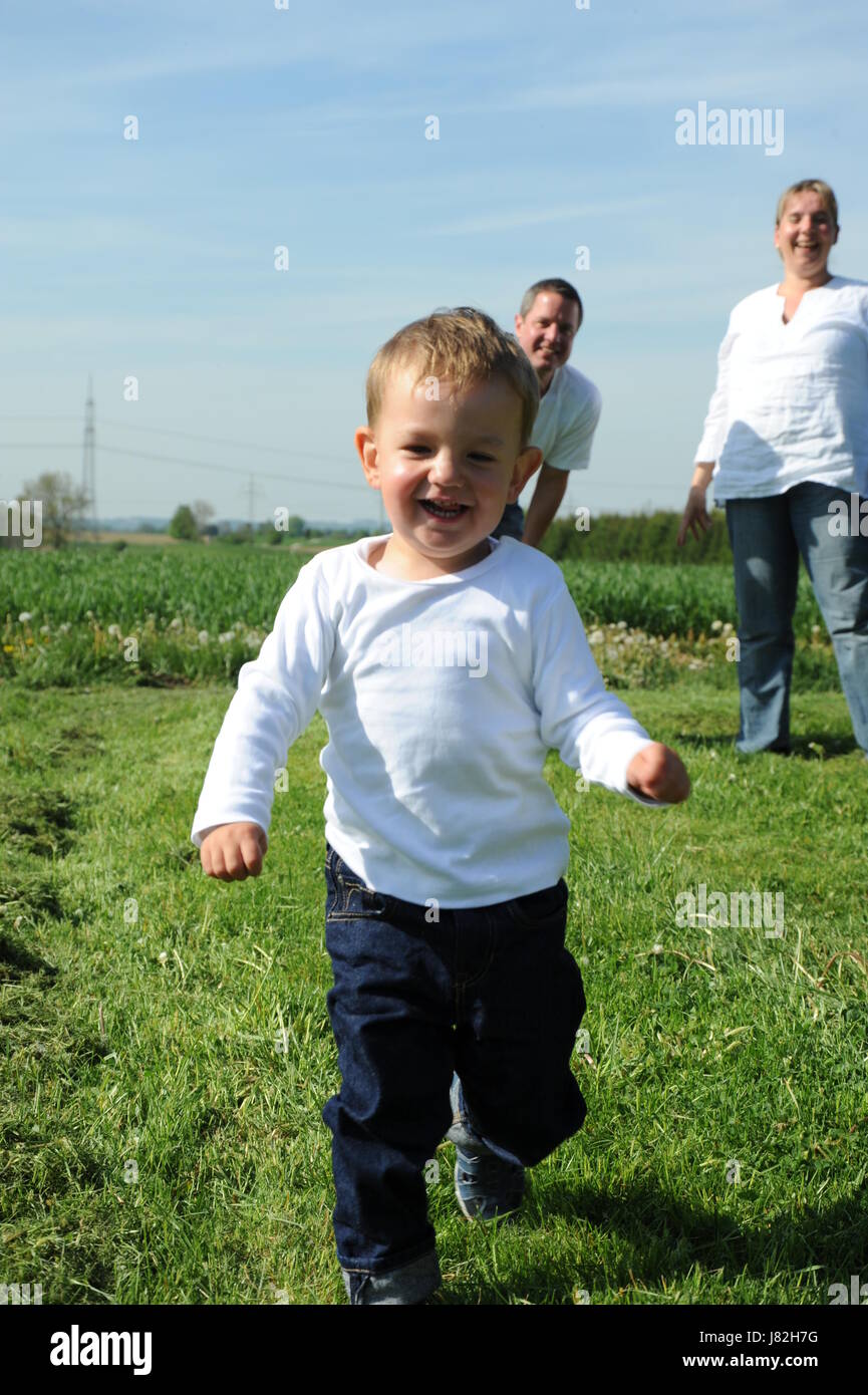 laughing little boy running Stock Photo - Alamy