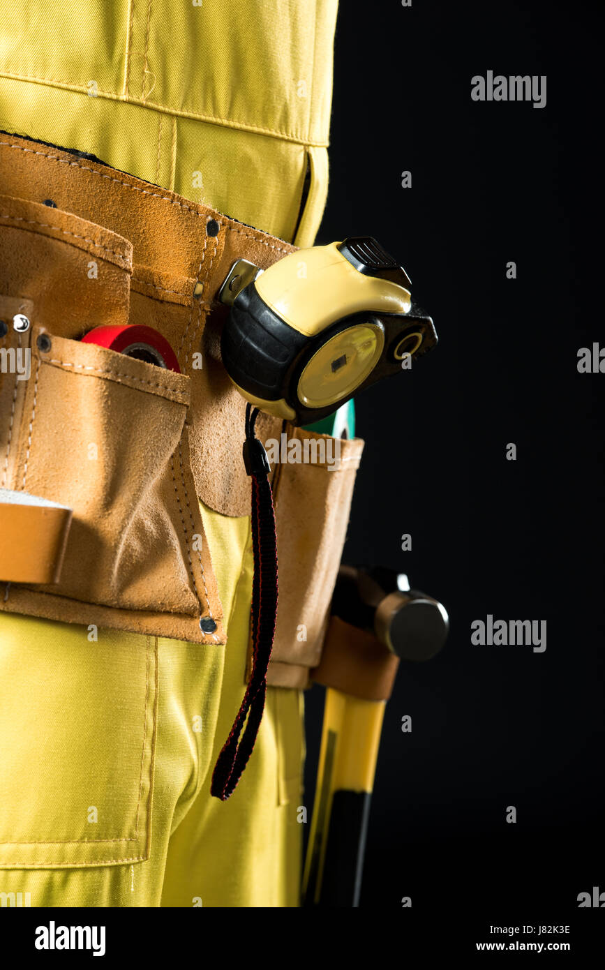 Close-up partial view of workman in tool belt on black Stock Photo - Alamy