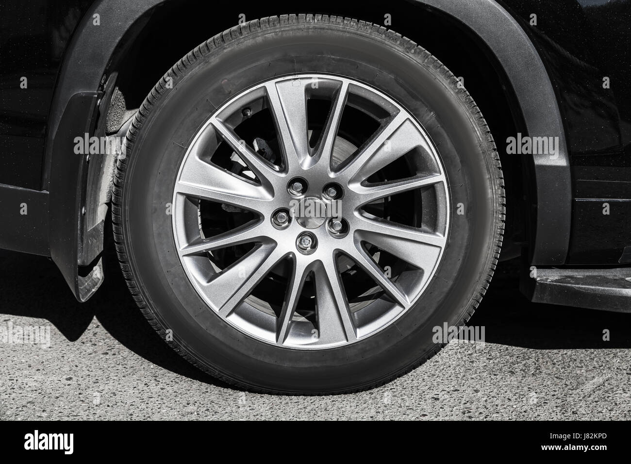 Modern crossover car wheel on asphalt road, close-up frontal photo ...