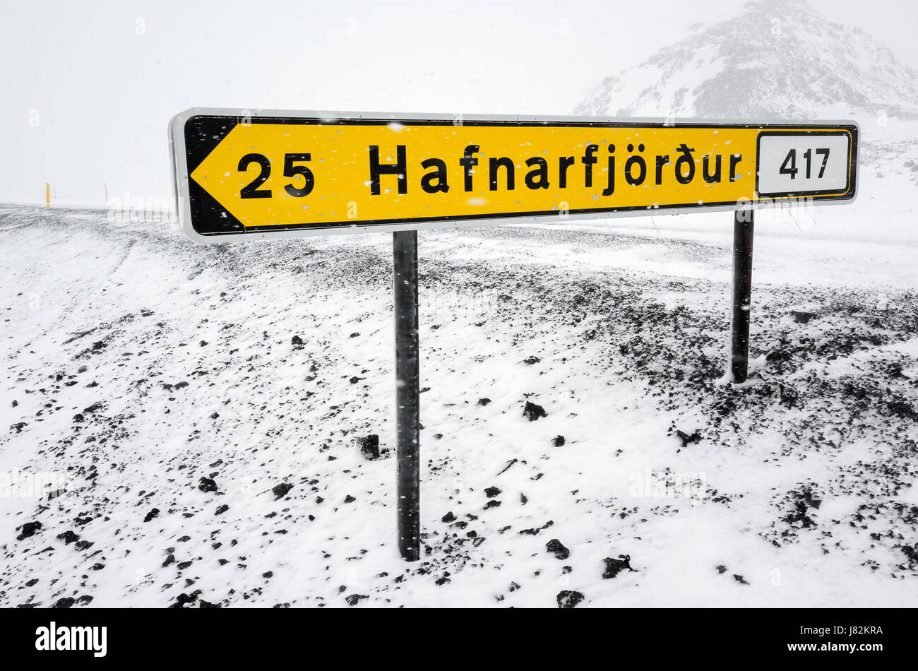 Yellow Icelandic road sign with destination and distance stands on the ...