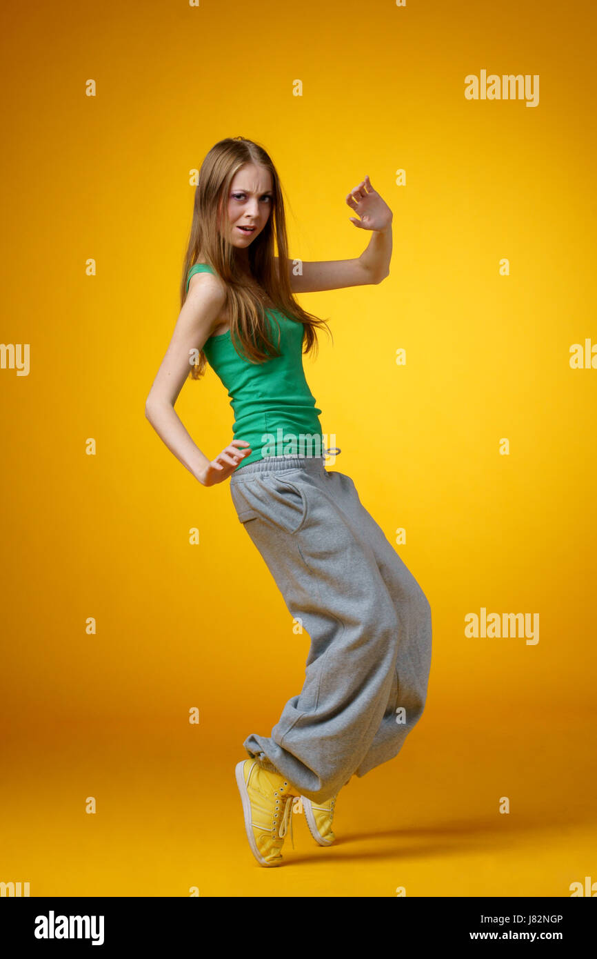 female breakdancer posing on yellow background Stock Photo - Alamy