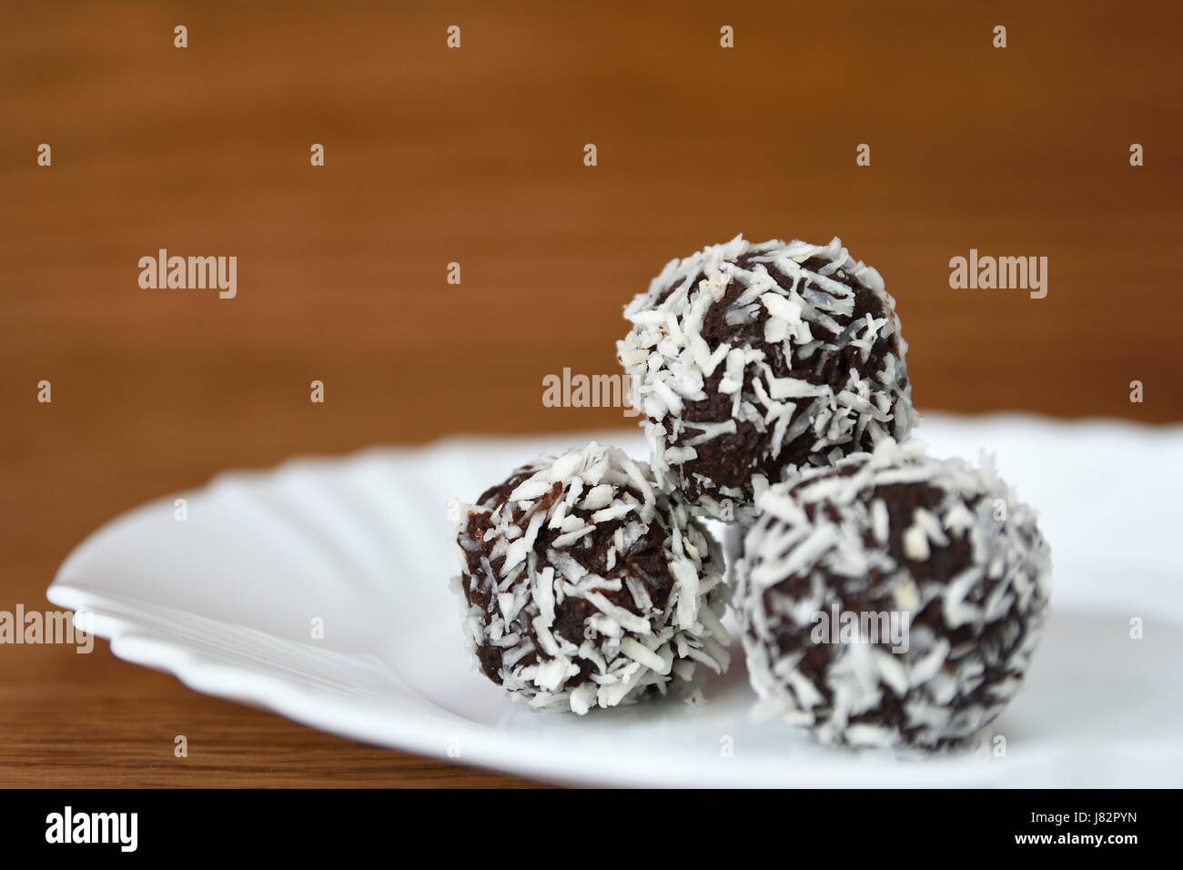 Christmas sweets on a plate - Rum balls in coconut. Traditional ...