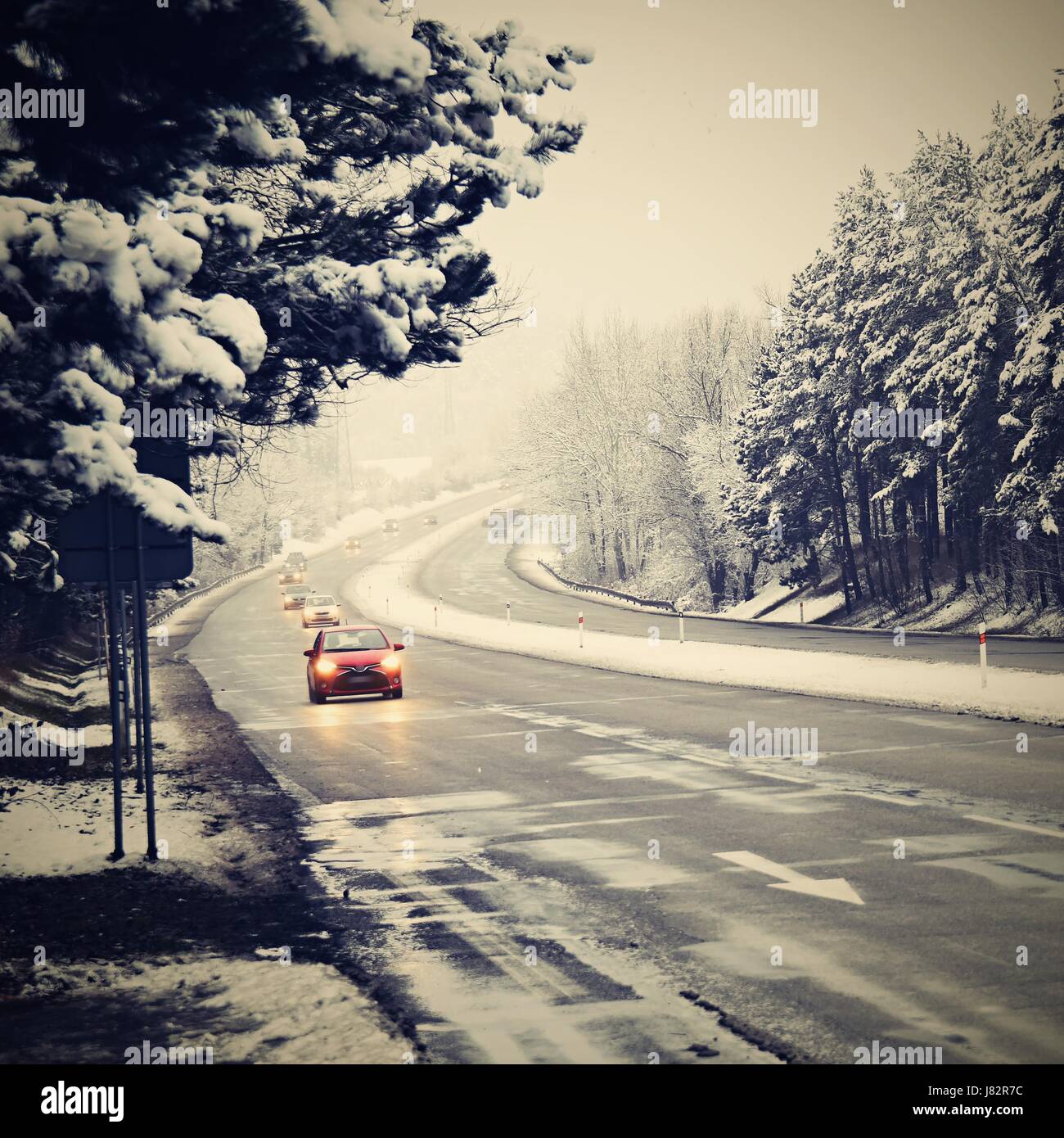 Cars on winter road with snow. Dangerous automobile traffic in bad ...