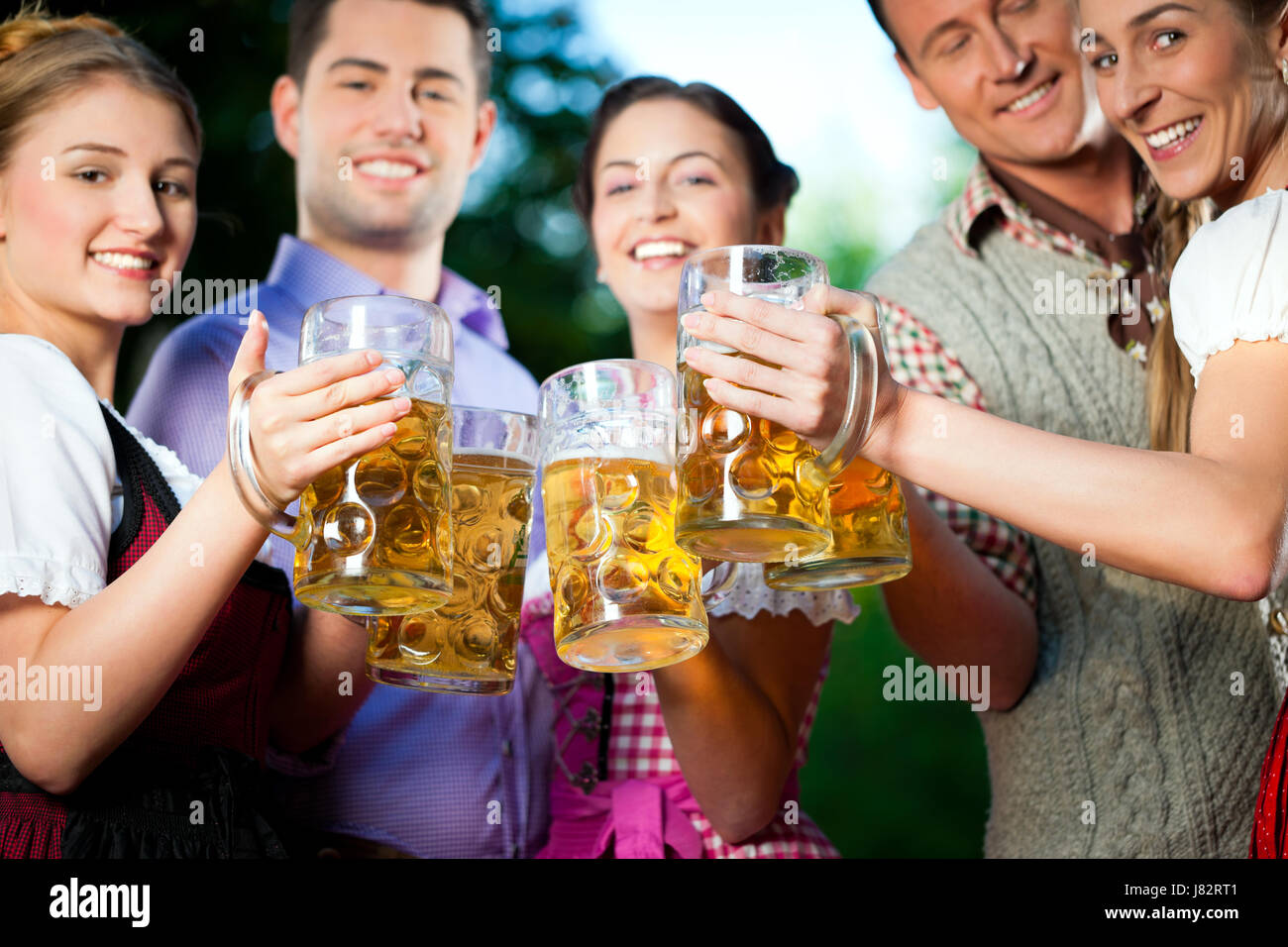 in beer garden - friends drinking beer Stock Photo - Alamy